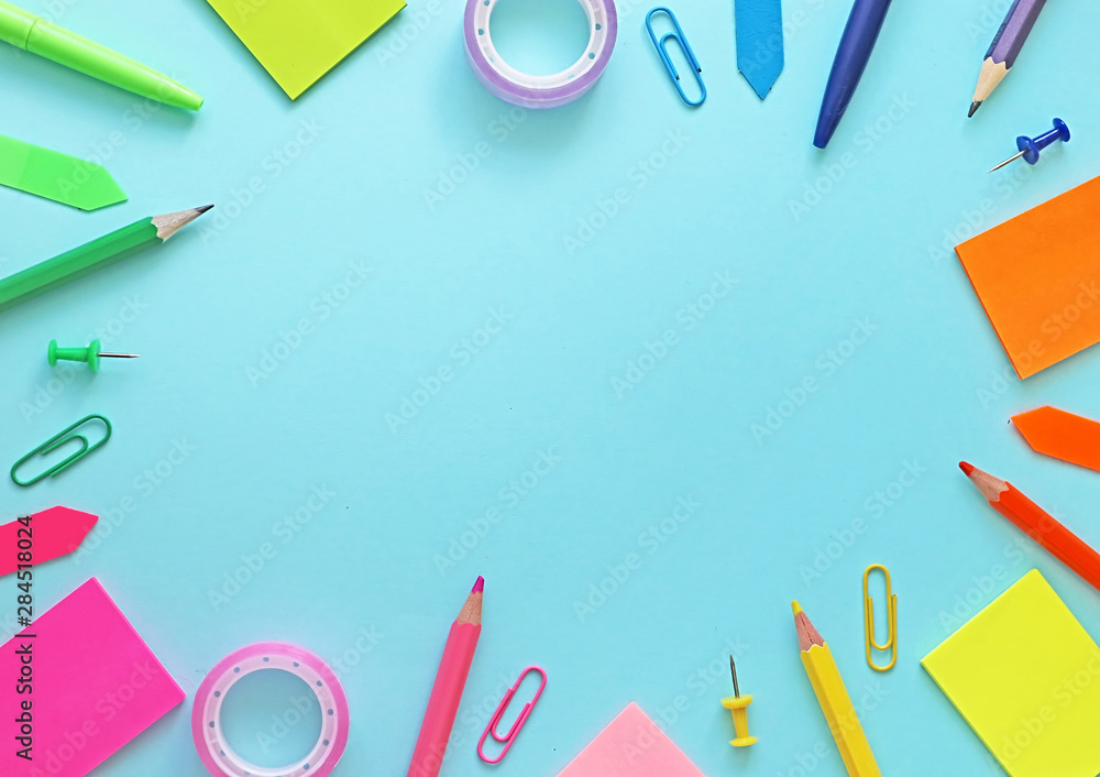 Colorful school items as a frame on blue background. Flat lay, top view ...
