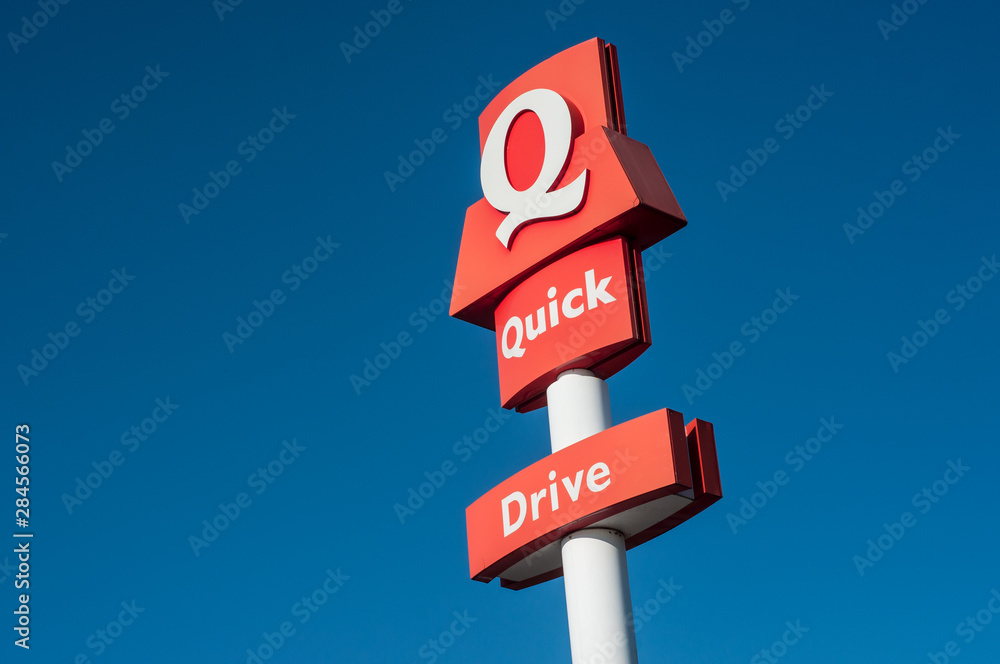 Quick fast food logo on a pole on blue sky background . Quick is a ...