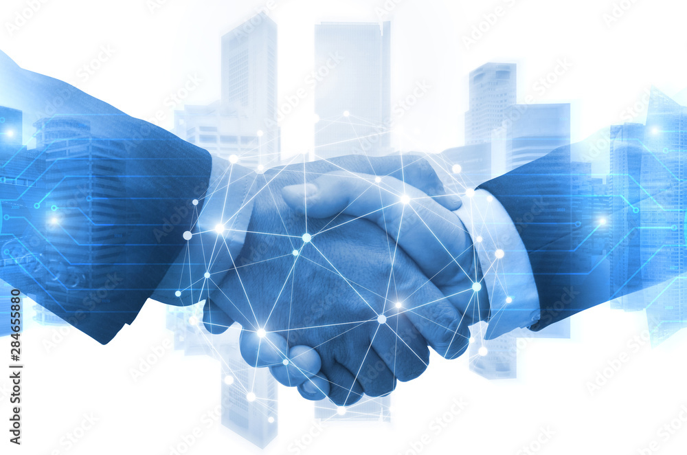 Partnership - business man shaking hands with effect digital network ...