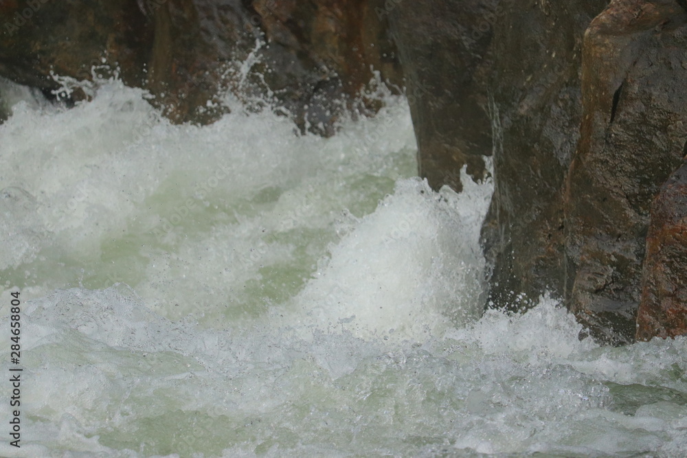 water falling between rocks from waterfalls Stock Photo | Adobe Stock