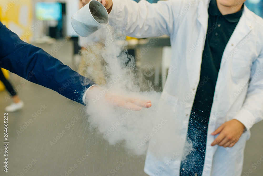 Chemical event at the birthday party: children's hands touch the smoke ...