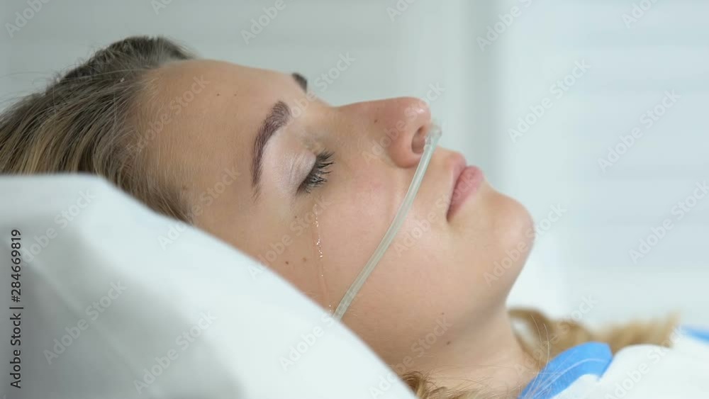 Sad crying woman with nasal cannula lying hospital bed, disease ...
