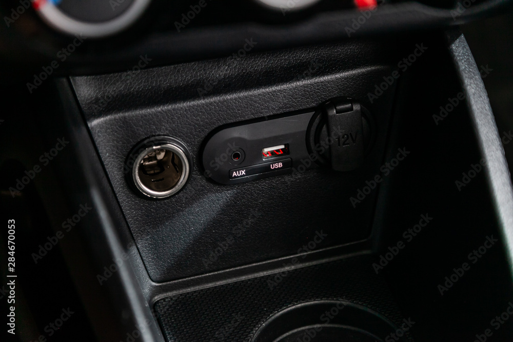 Close up of a charging in the car, cigarette lighter, aux, usb ...