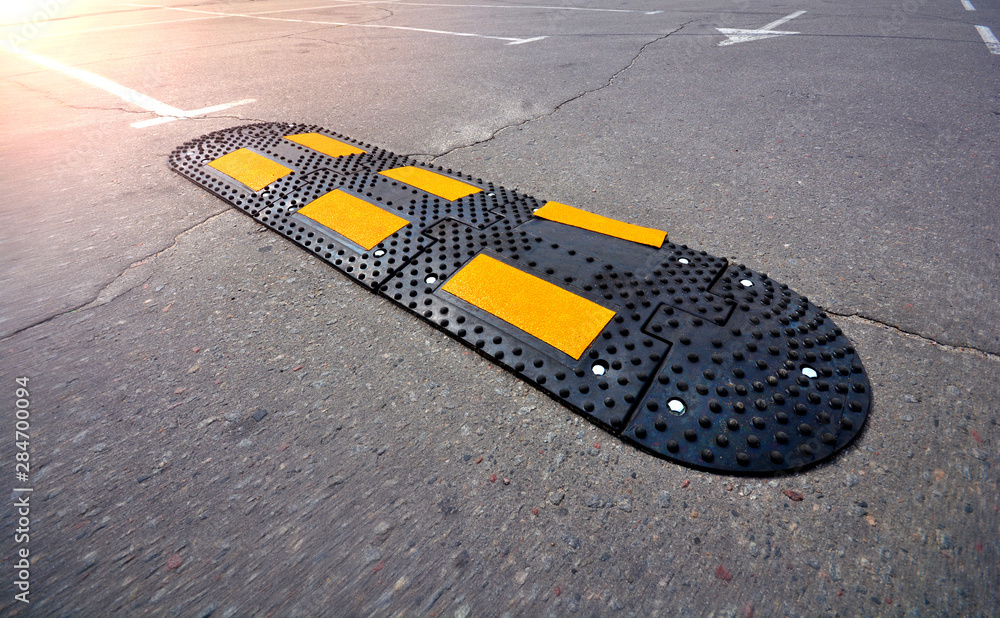 Speed bump on asphalt road. Speed Limit Tool in a city. Stock Photo ...