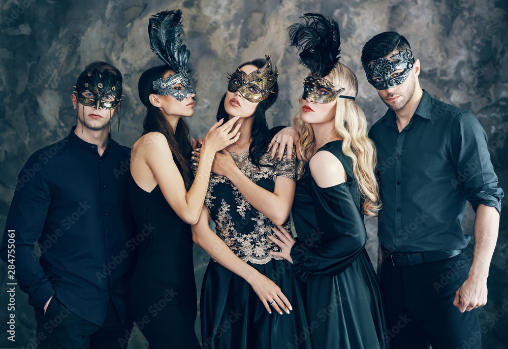 Group of people in masquerade carnival mask posing in studio Stock ...