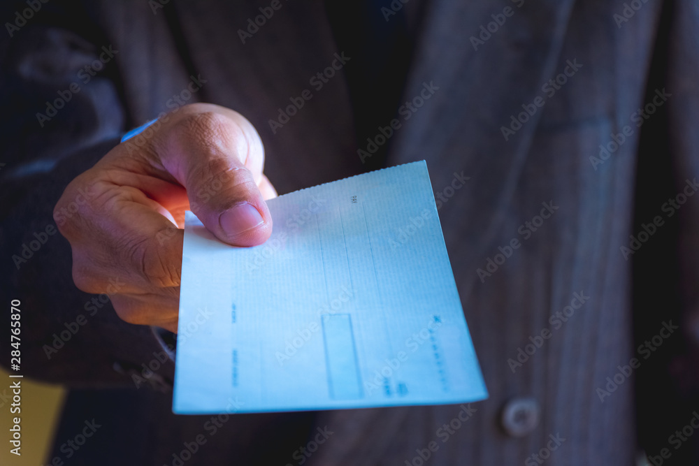 Business man or manager hand holding and giving bank check to the other ...