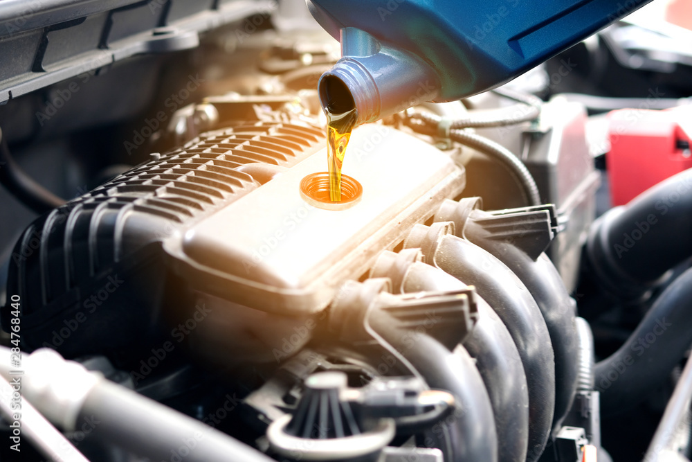 Refueling and pouring oil quality into the engine motor car ...