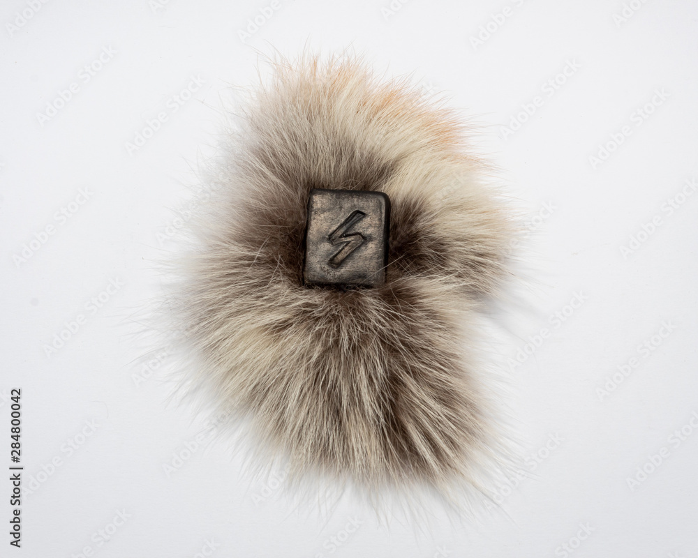 Norse rune Sowilo, isolated on fur and white background. The sun ...