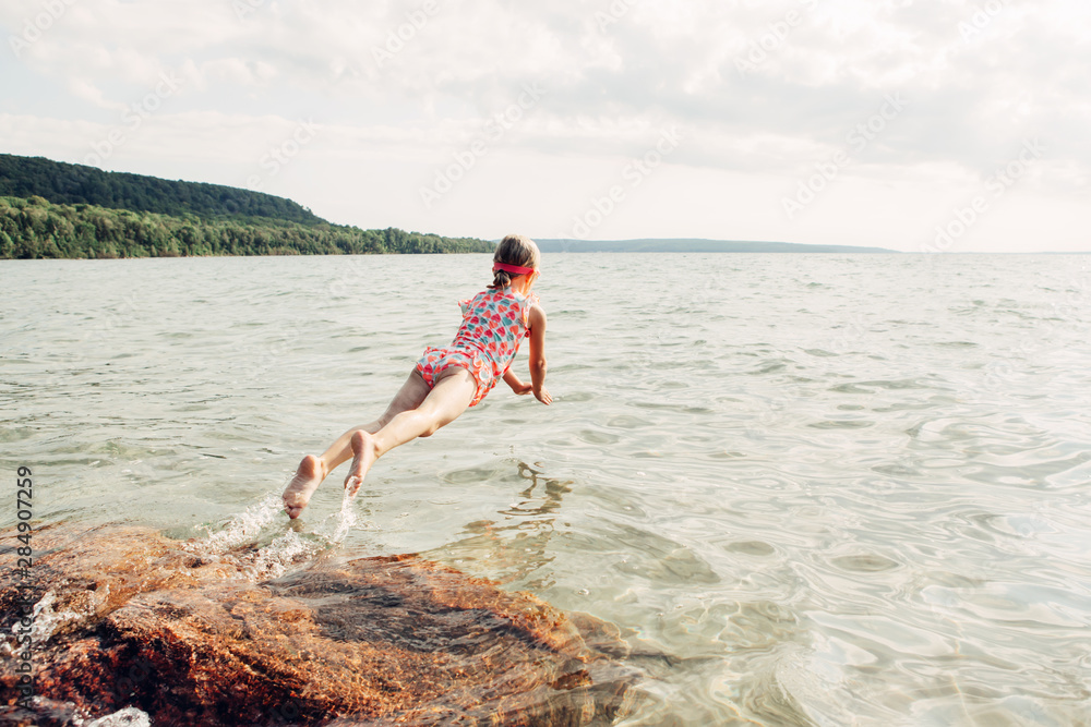 Caucasian girl swimming in lake river with underwater goggles. Child ...