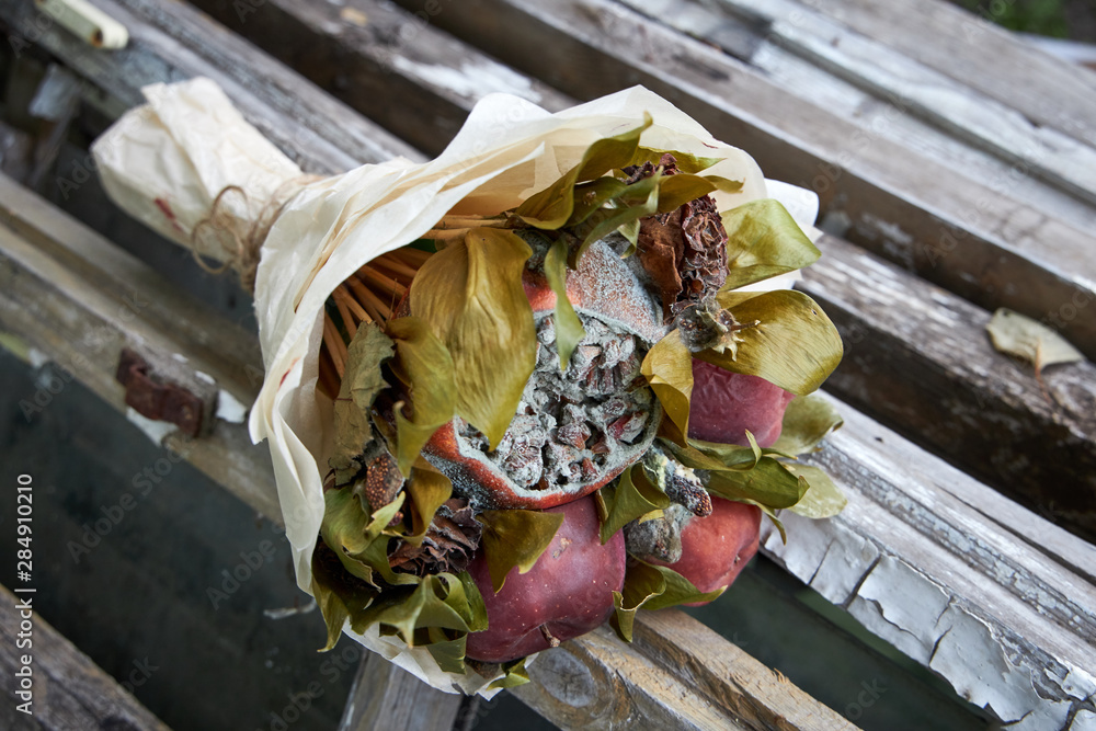 Bunch of rotten fruit and wilted flowers as a symbol of faded love ...