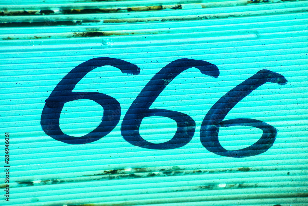 Plastic wall with devil or satan number 666. Dirty ribbed plastic ...