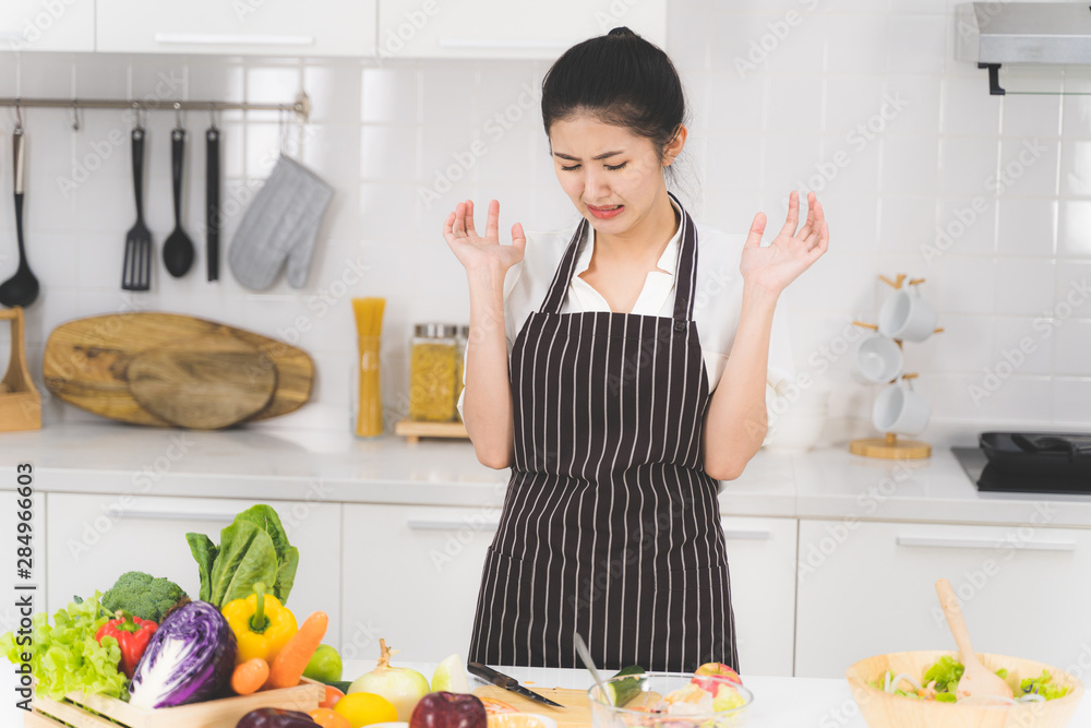 Young asian woman or housewife is tired of cooking, which consists of a ...