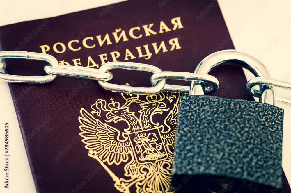 Russian passport close-up, chain and lock on the background, concept ...