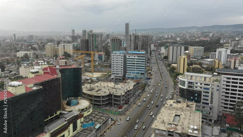 Drone shot flying towards modern Addis Ababa skyline with commercial ...
