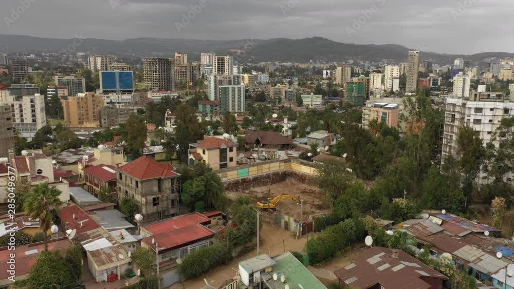 Flying over residential neighborhood in Addis Ababa, with tree filled ...