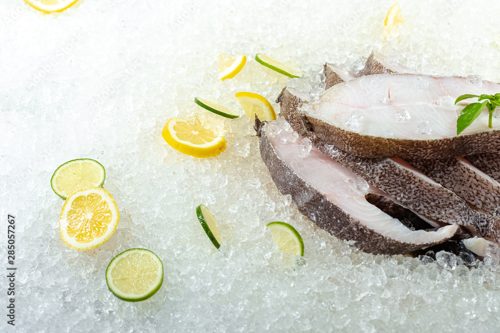 fresh sea ocean white fish sliced in pieces, lying on ice, headless ...