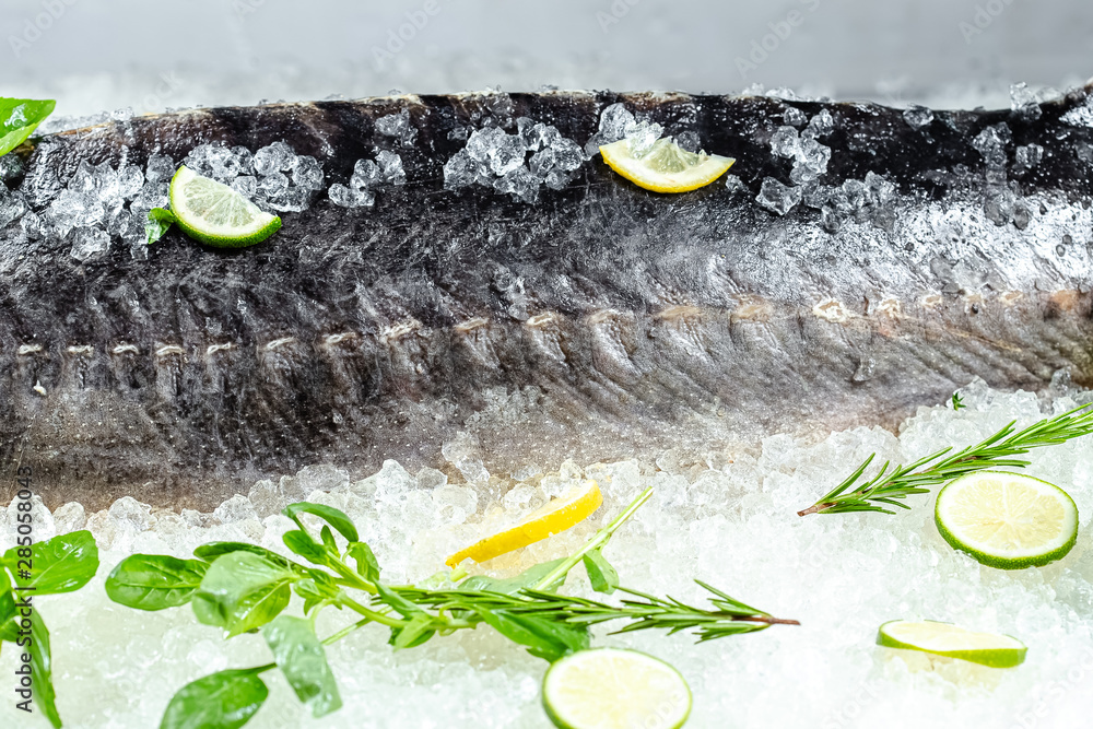 fresh sea ocean sturgeon fish, lies on ice, without and with a head ...