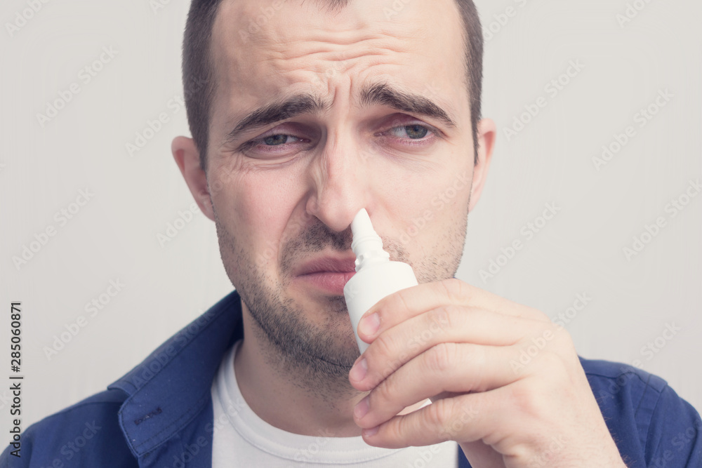 The man caught cold, sniffing nasal spray, medication for blocked nose ...