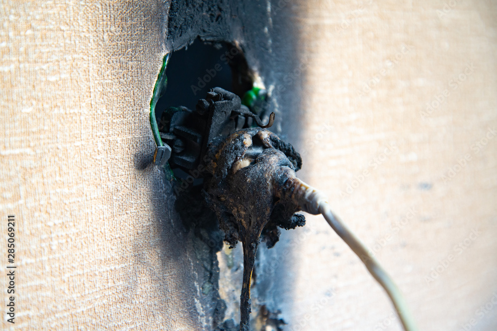 Burnt power outlet. Melted-off and burned plastic socket of power ...