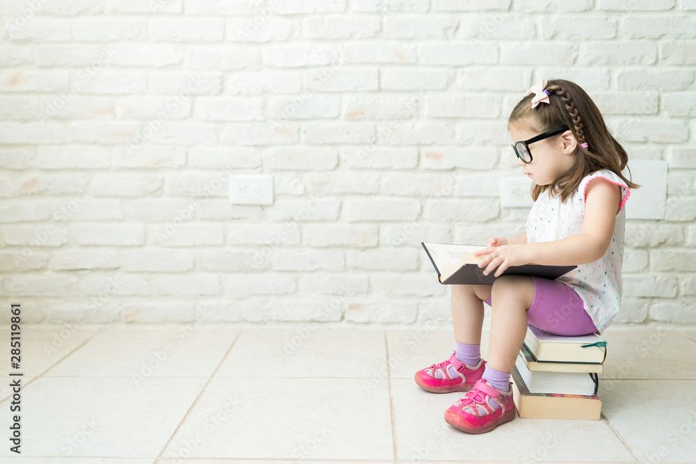 Kid Reading Textbooks At Living Room Stock Photo | Adobe Stock
