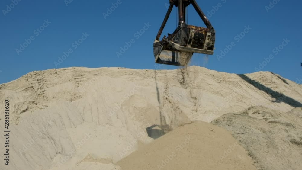 Extraction of river sand. Gantry cranes on the riverport loads sand ...
