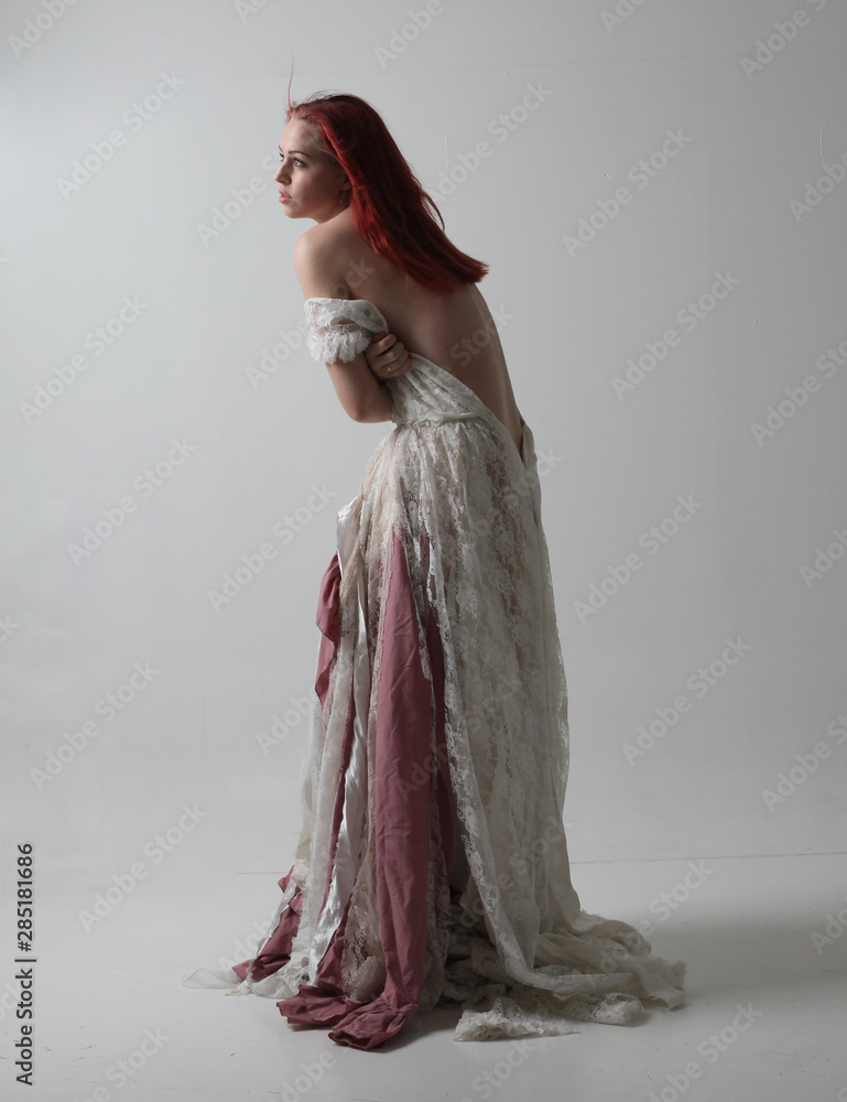 full length portrait of red haired girl wearing torn and tattered ...