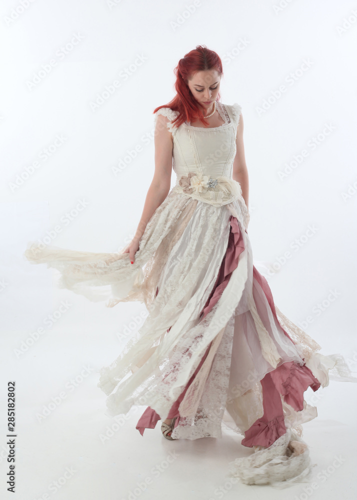 full length portrait of red haired girl wearing torn and tattered ...