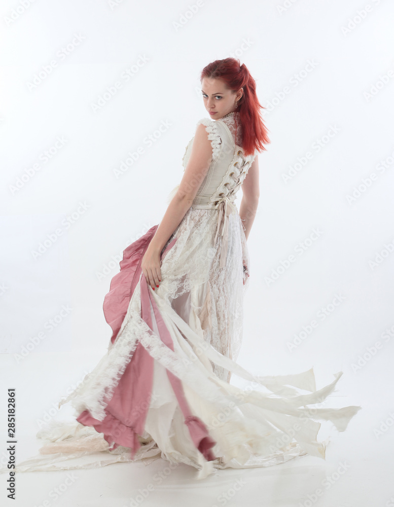full length portrait of red haired girl wearing torn and tattered ...
