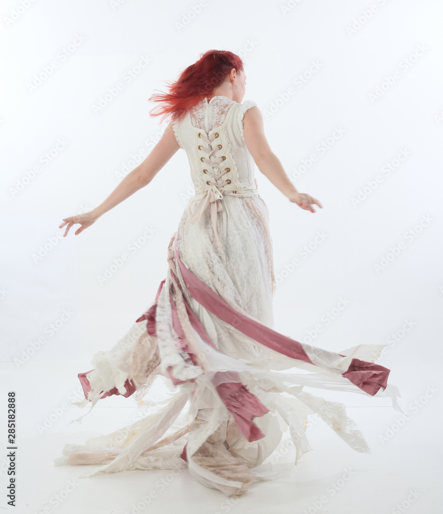 full length portrait of red haired girl wearing torn and tattered ...
