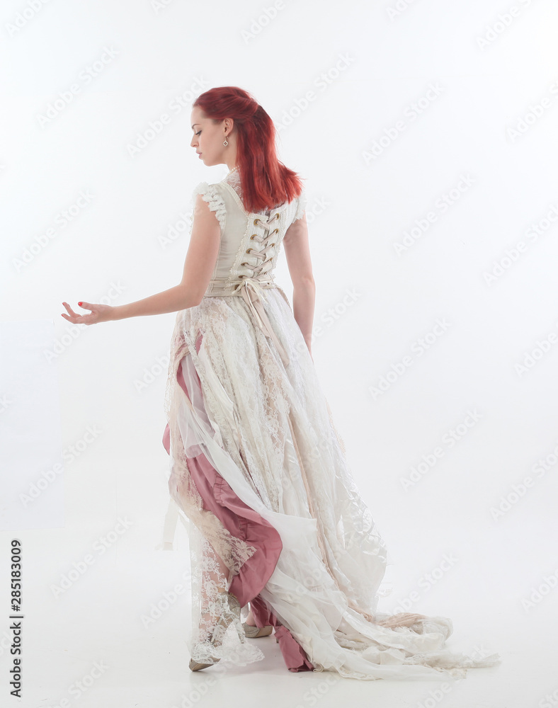 full length portrait of red haired girl wearing torn and tattered ...