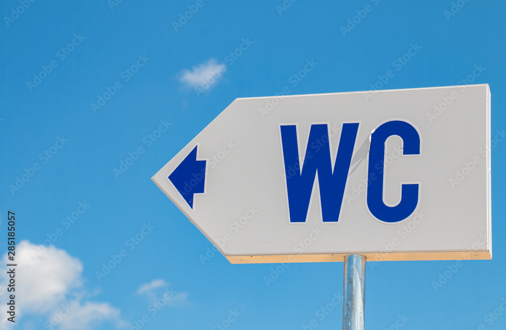 Restroom sign on blue sky background. Toilet sign - restroom concept ...