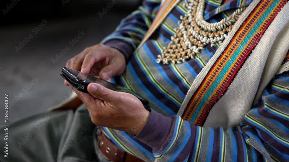 4K, Close up of aboriginal hand using smartphone and dressed a ...