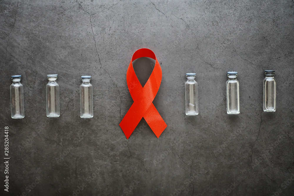Symbol of human immunodeficiency virus disease. Red ribbon. A helping ...