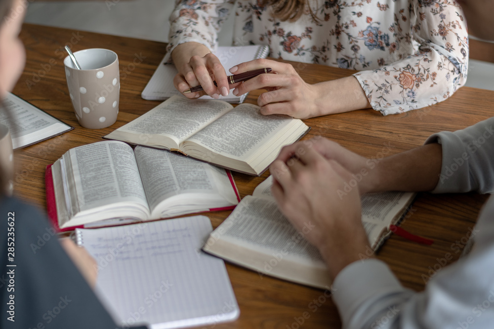 Christian worship and praise. Happy friends praying and reading the ...