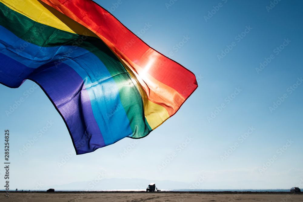 rainbow flag waving on the blue sky Stock Photo | Adobe Stock