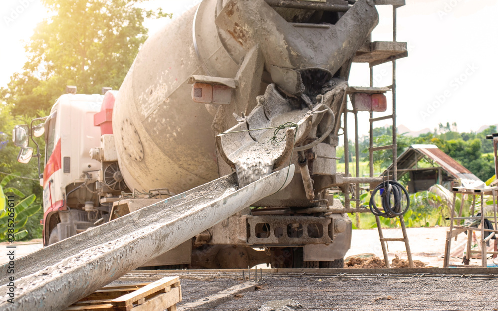 Precast concrete trucks and construction workers are pouring wet ...