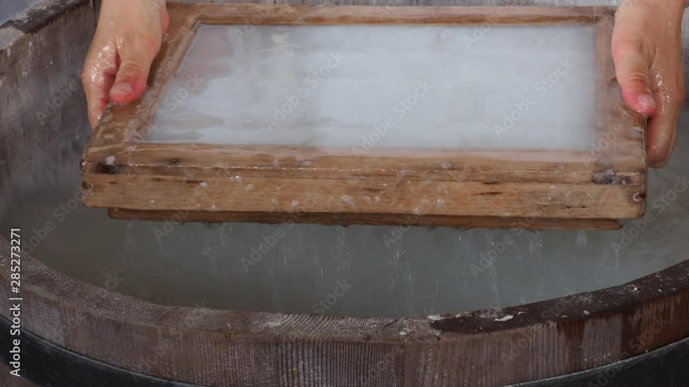 Demonstration of the medieval way to make paper from natural fibers and ...