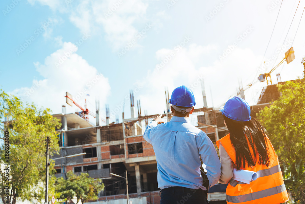 Poster Asian man civil engineer and woman architect wearing blue safety ...
