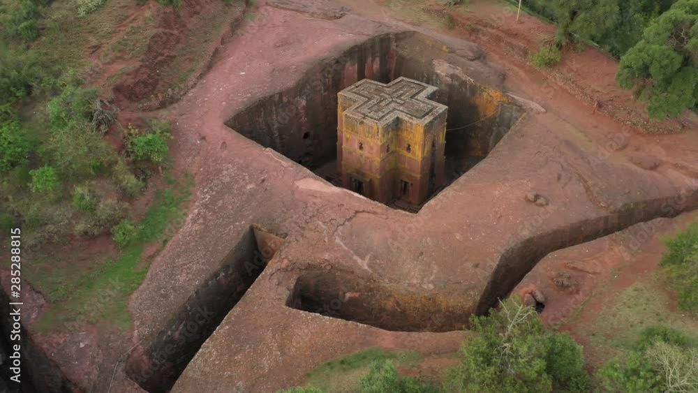 Ascending tilting drone flight of Church of Saint George in Lalibela, well preserved historic ...
