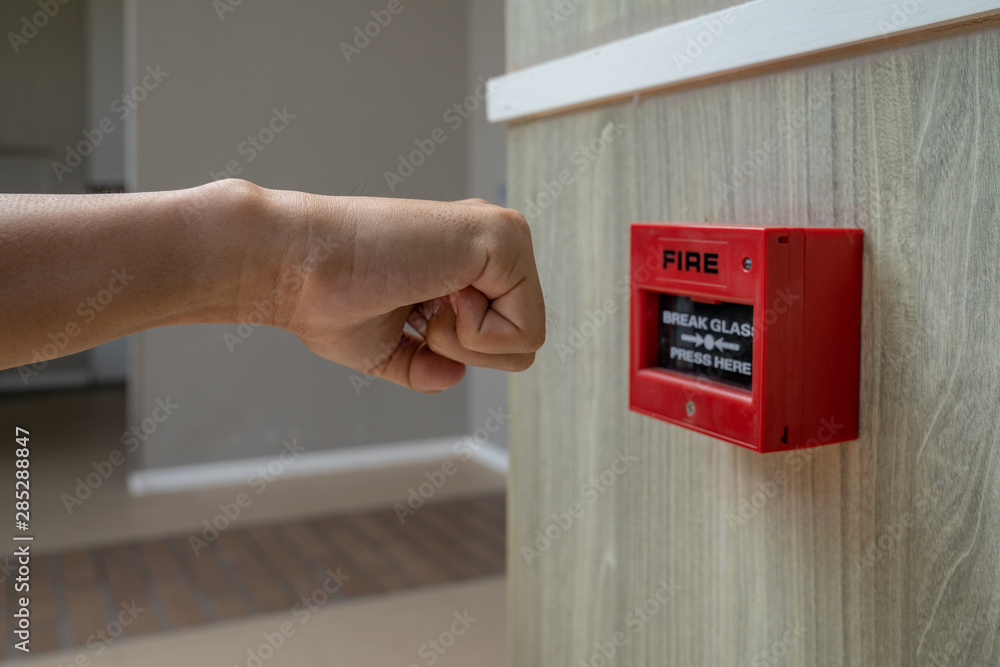 Fire alarm box with human hand action to crush the glass for emergency ...