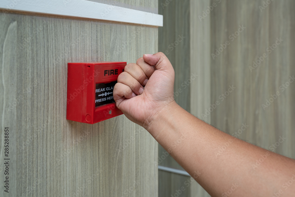 Fire alarm box with human hand action to crush the glass for emergency ...