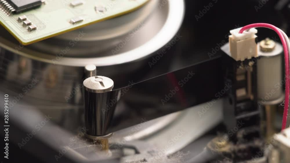 VCR cassette mechanism. Close-up. Rewind of magnetic videotape in the ...