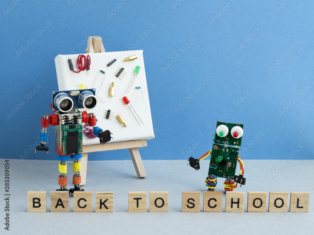 Back to school concept. A metal robot and an electronic board that can ...