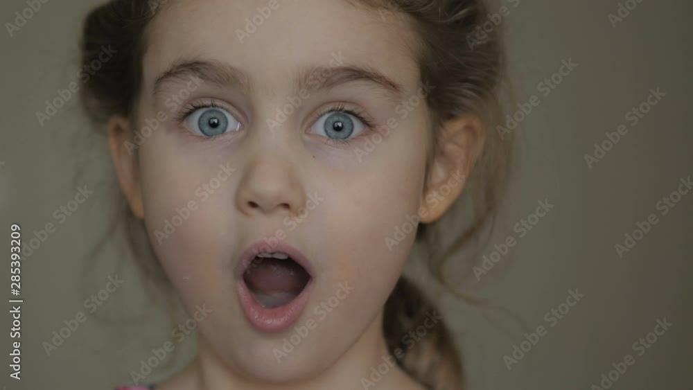 Slow motion. Girl looks and is surprised and happy to receive a ...