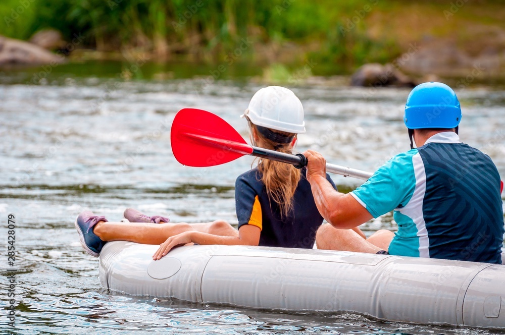 Rafting trip. Father and child rafting on the river in a rubber ...