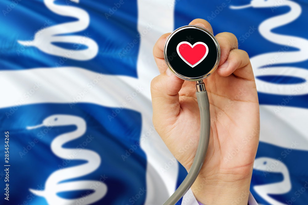 Doctor holding stethoscope with red love heart. National Martinique ...