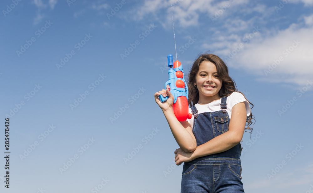 Little girl posing with water gun Stock Photo | Adobe Stock