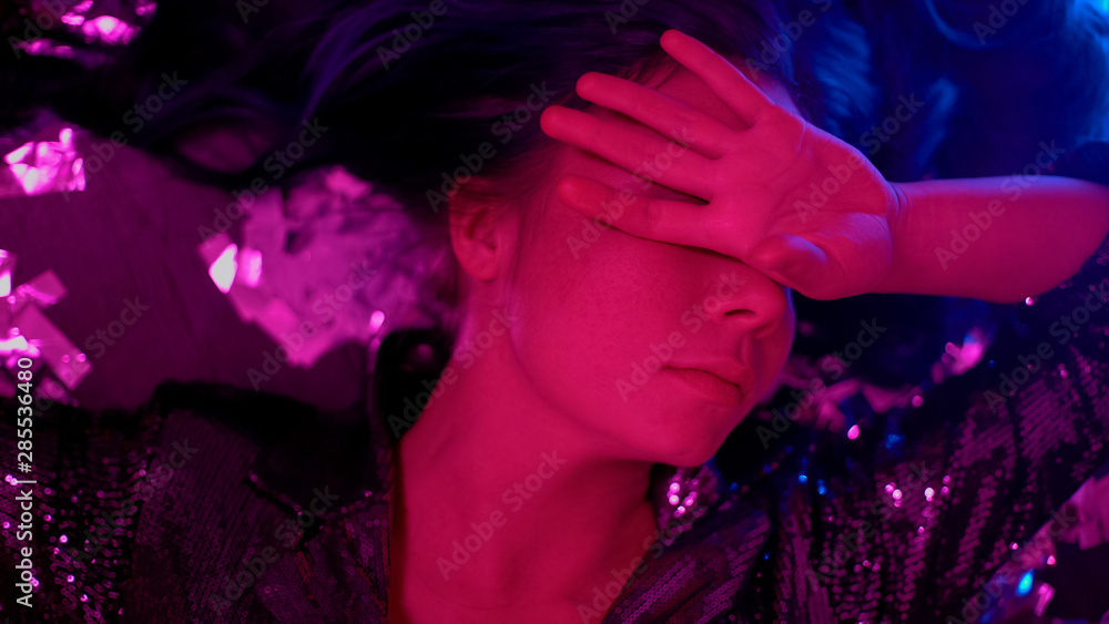 Drunk girl awakening on floor after party, feeling dizzy and sick, top ...