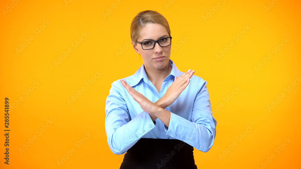 Critical office worker with crossed arms showing stop sign, business ...