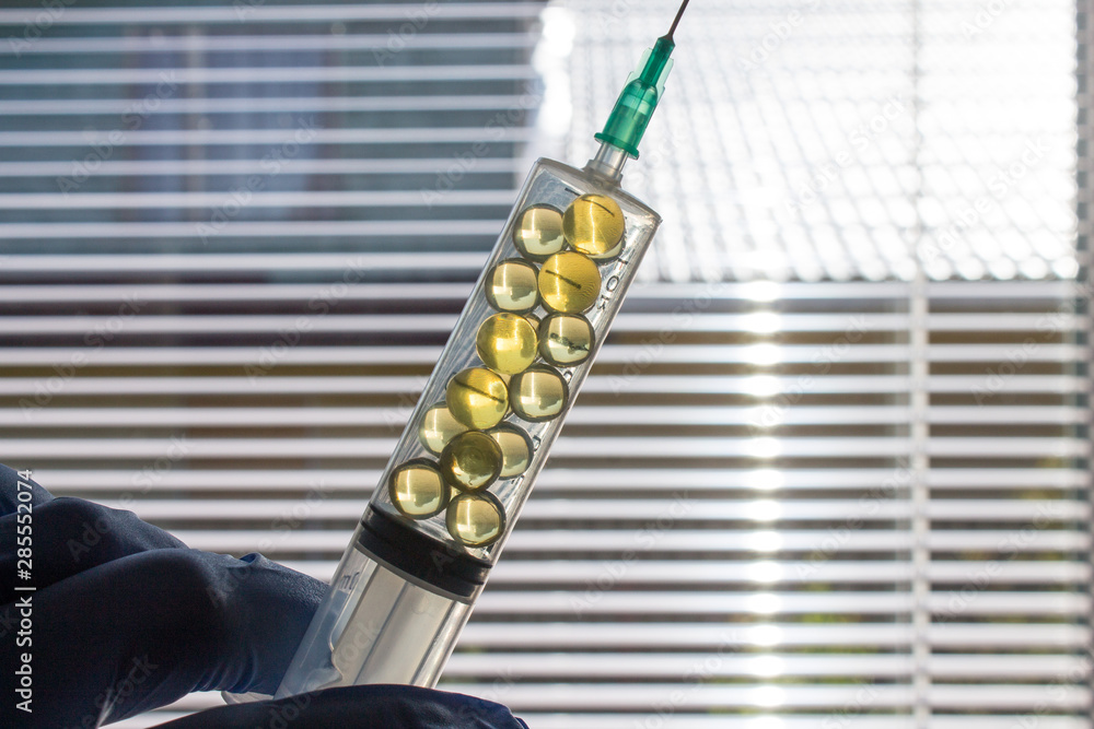 Medical syringe filled with yellow capsules with omega 3 vitamin Stock ...